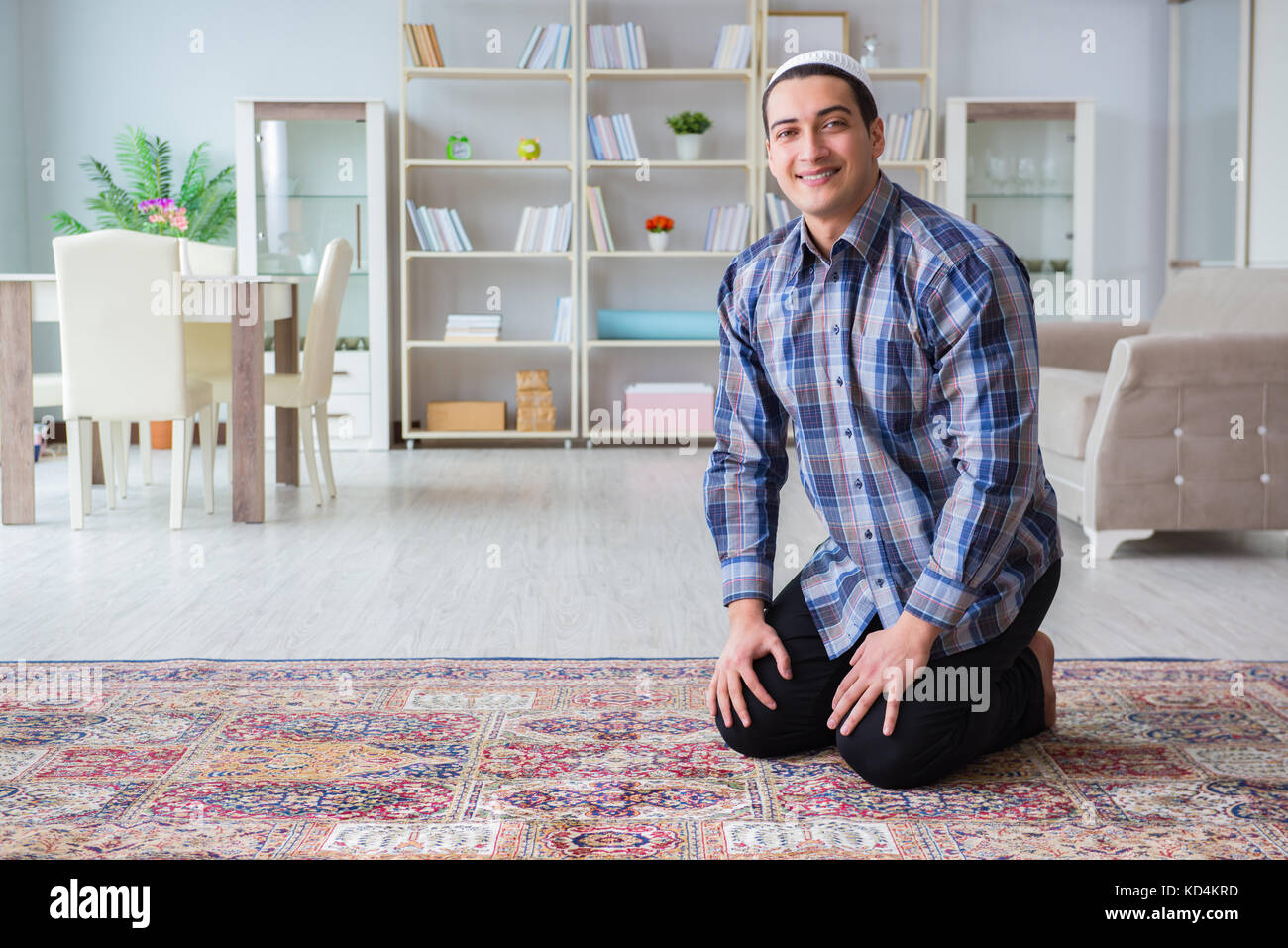 Young muslim man praying at home Stock Photo - Alamy