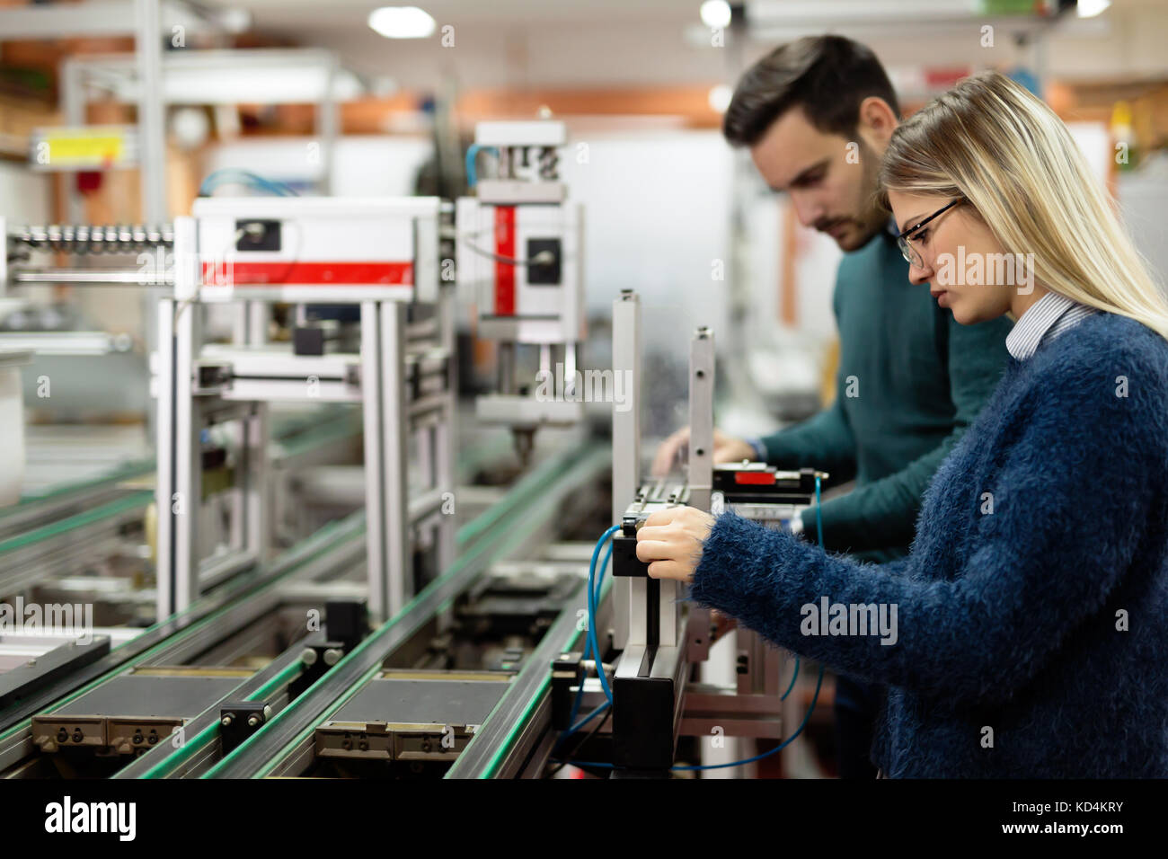 Two young handsome engineers working on electronics components Stock ...