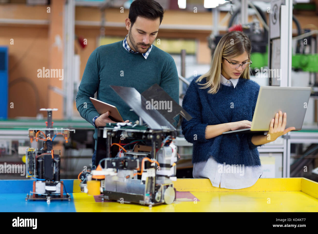 Young students of robotics preparing robot for testing Stock Photo - Alamy