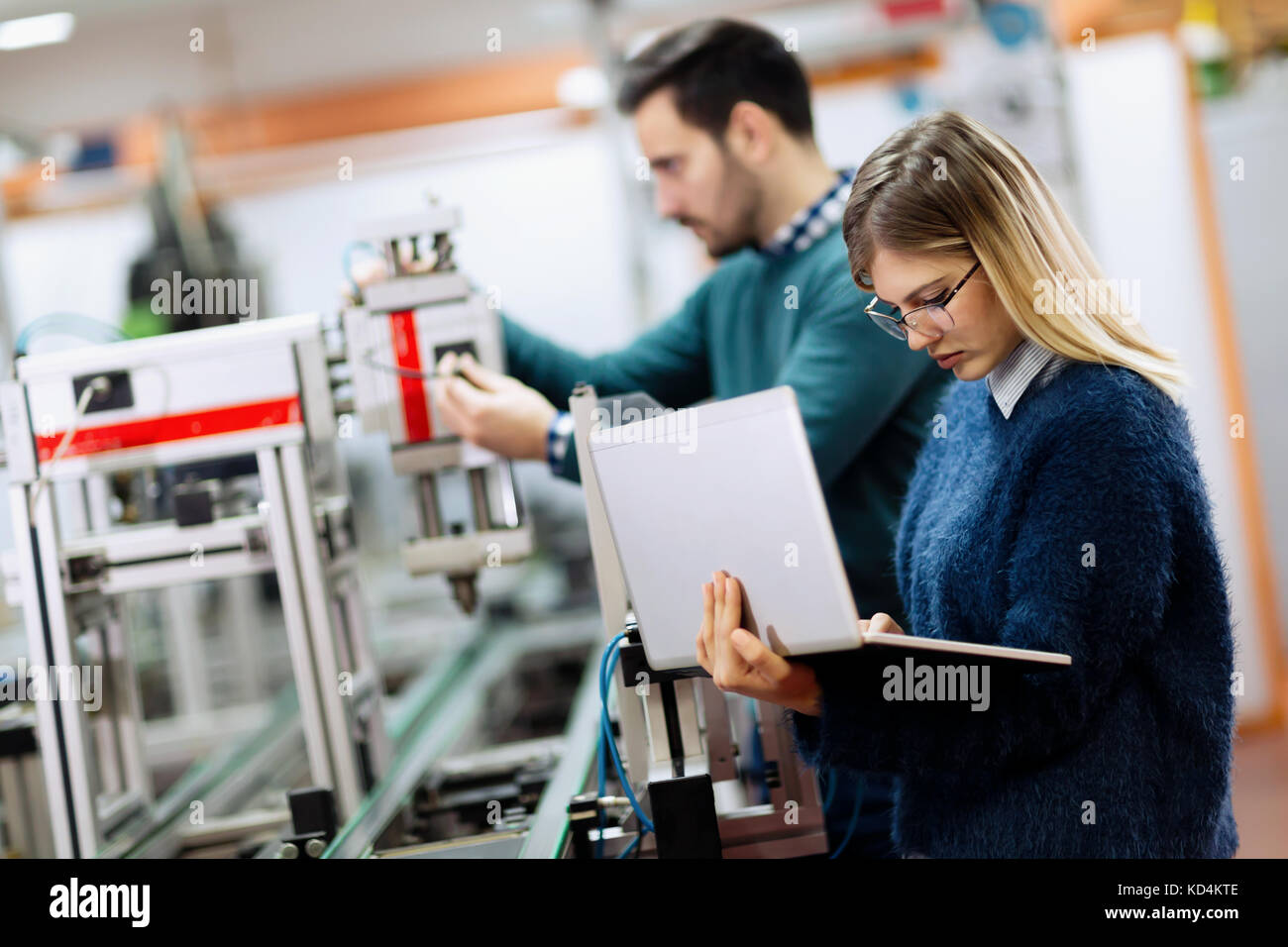 Two young handsome engineers working on electronics components Stock ...