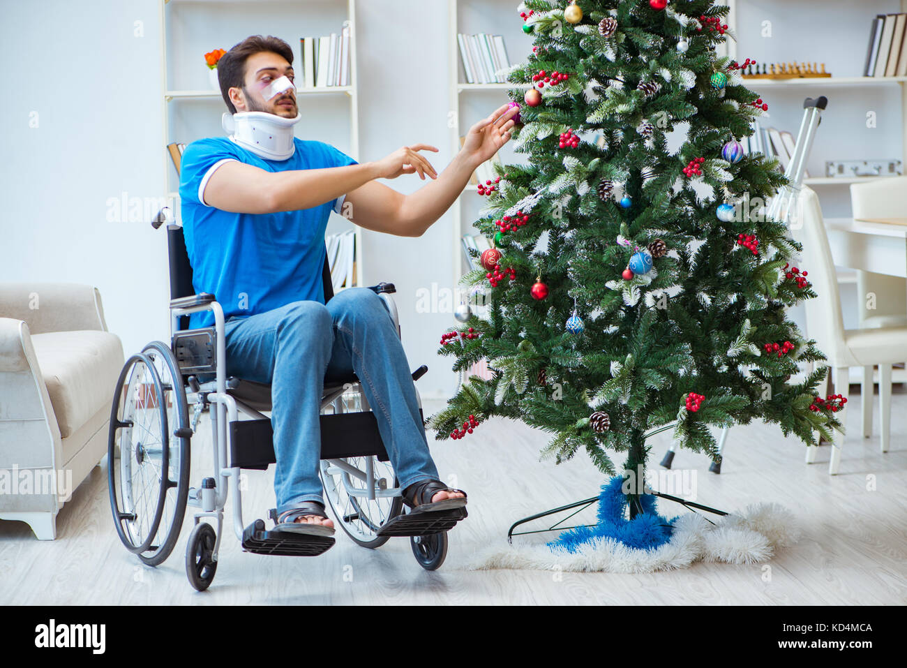Injured disabled man celebrating christmas at home Stock Photo - Alamy