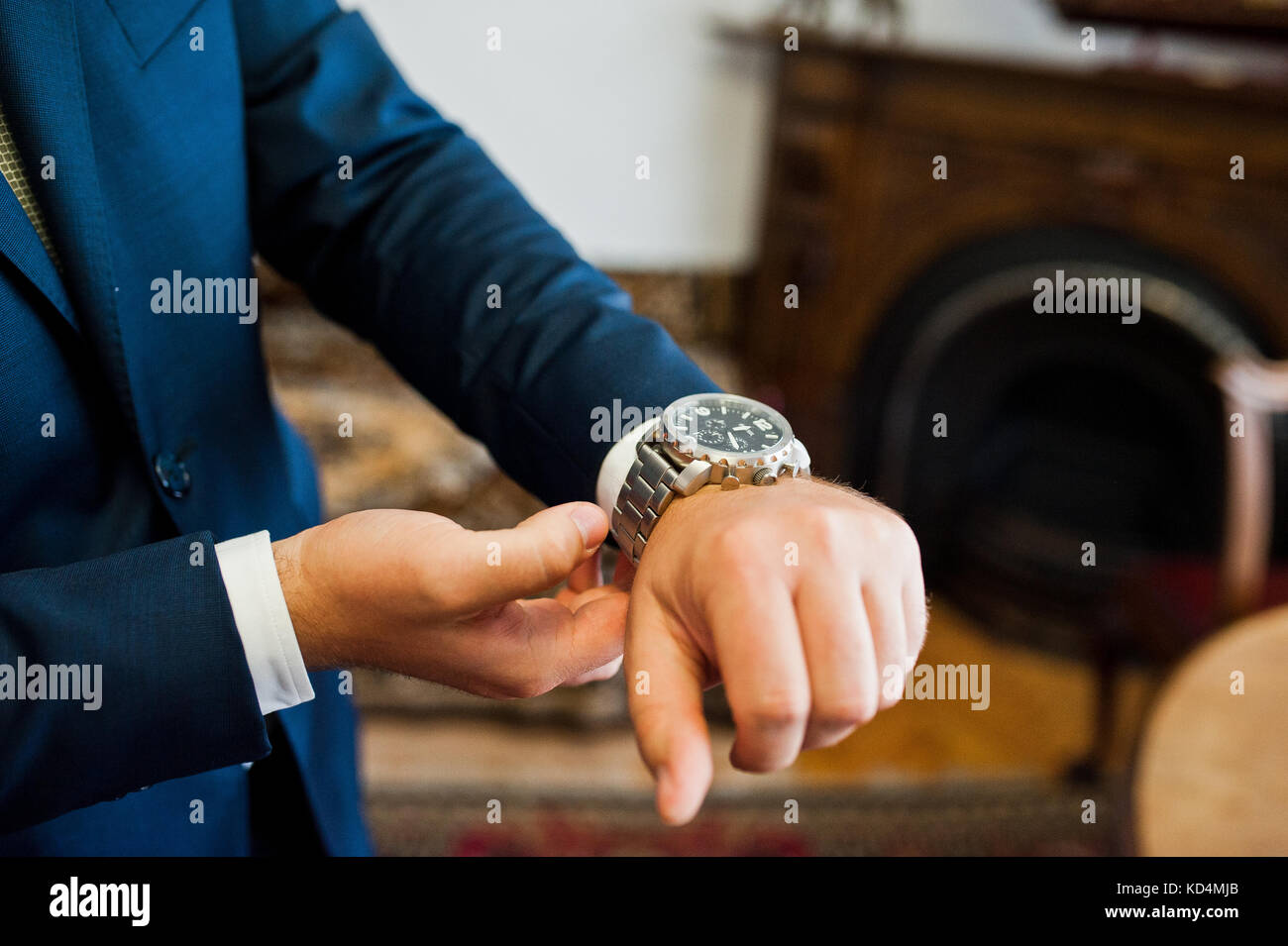 Close-up photo of a groom putting on a golden watch on his wrist Stock ...