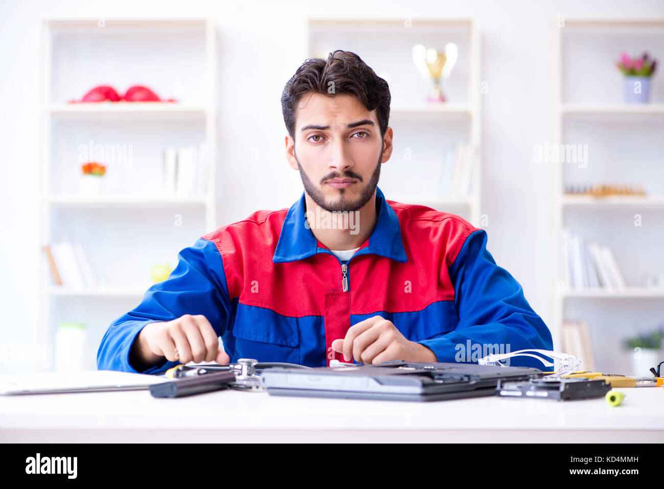 Repairman working in technical support fixing computer laptop ...