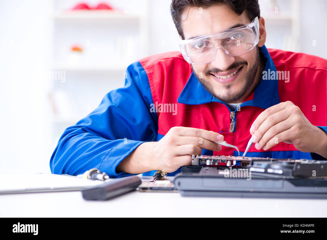 Repairman working in technical support fixing computer laptop ...