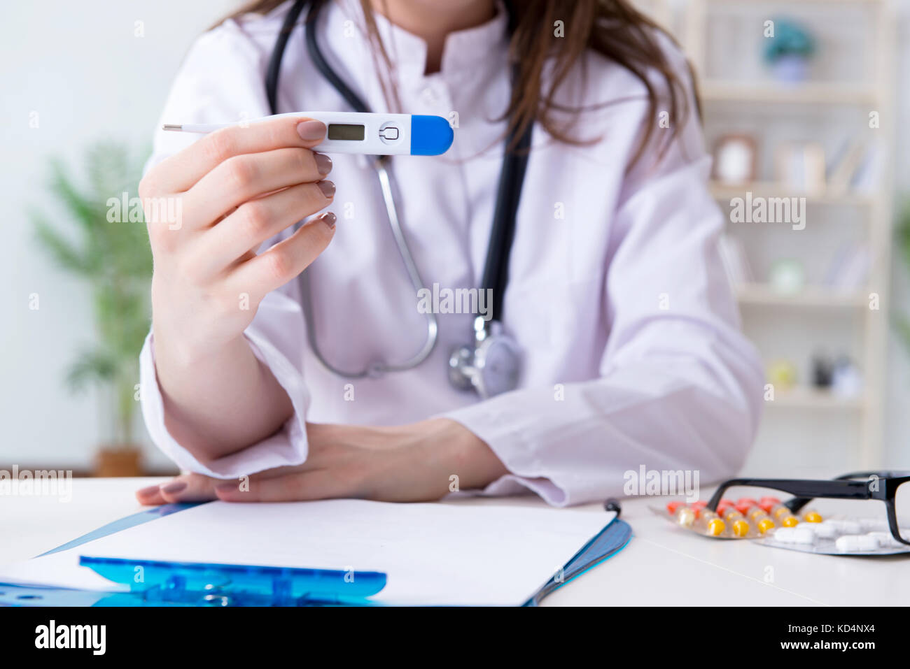 Doctor with thermometer in the hospital Stock Photo - Alamy