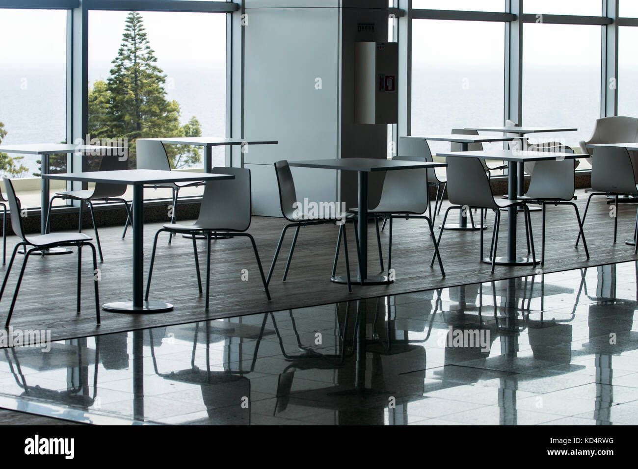 View of several white waiting room chairs and tables Stock Photo - Alamy