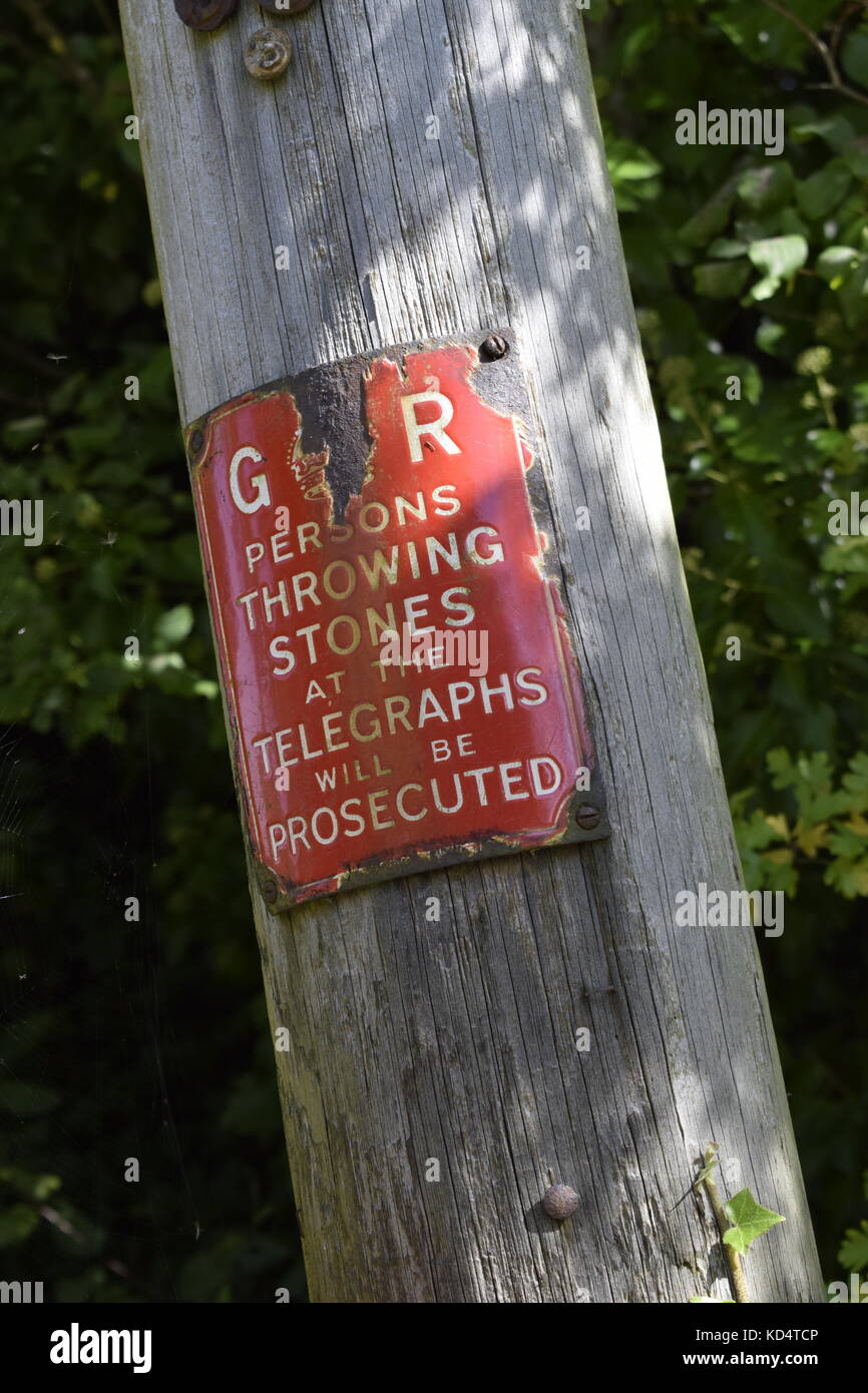 Warning sign on telegraph pole Stock Photo - Alamy