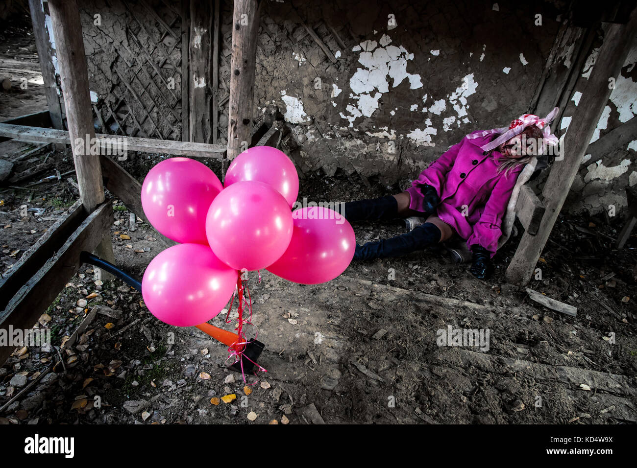 Balloons at the background of a dead girl in a pretty pink coat Stock ...