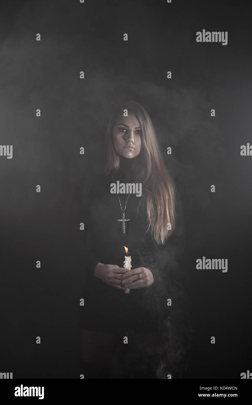 Mysterious woman and candle hi-res stock photography and images - Alamy
