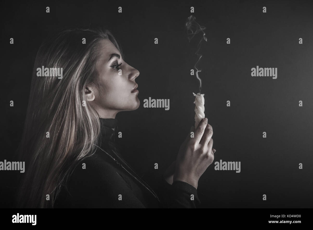 Girl holding candle in dark hi-res stock photography and images - Alamy