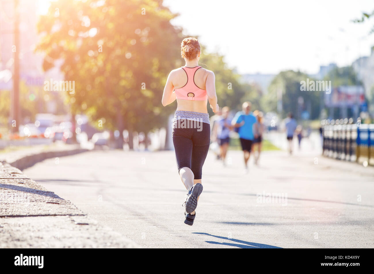 Slim woman running on the street in the morning. Healthy lifestyle ...