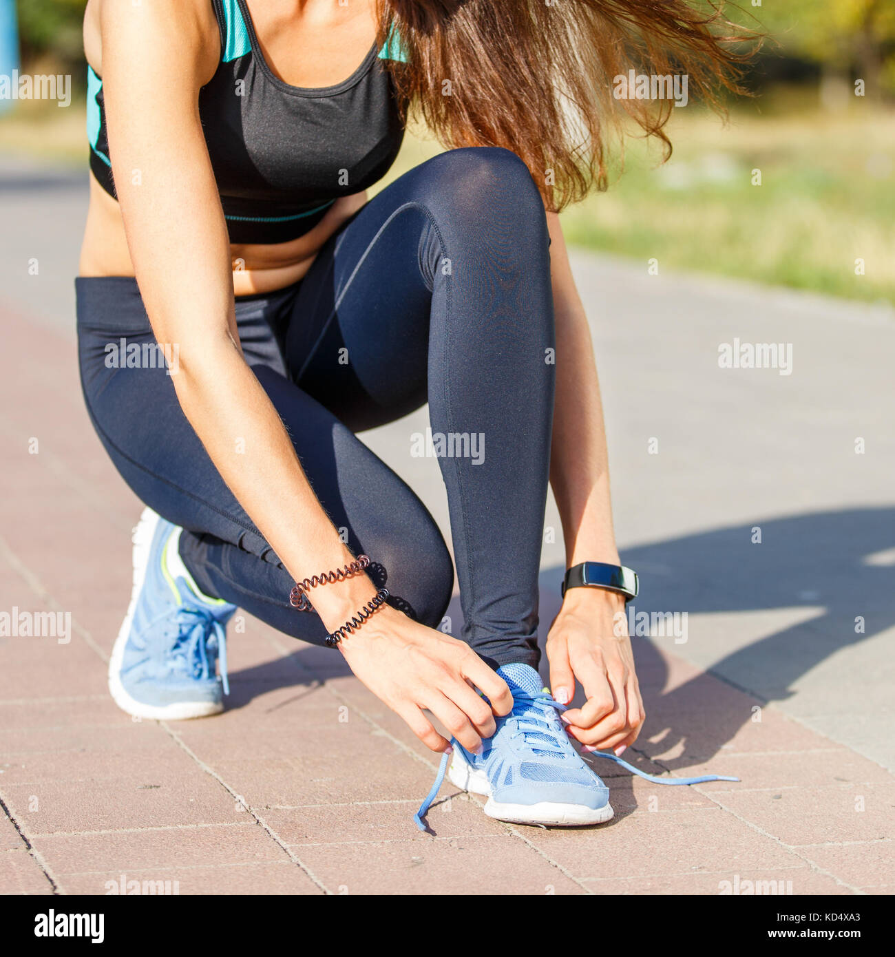 Girl lacing her shoes hi-res stock photography and images - Alamy