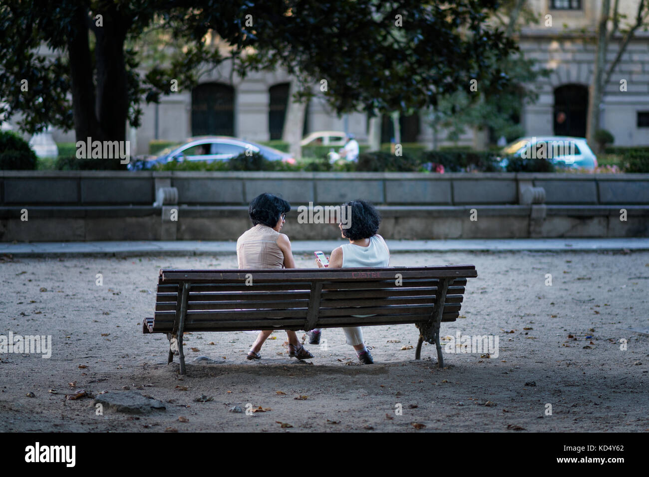 Two women sitting on a bench hi-res stock photography and images - Alamy