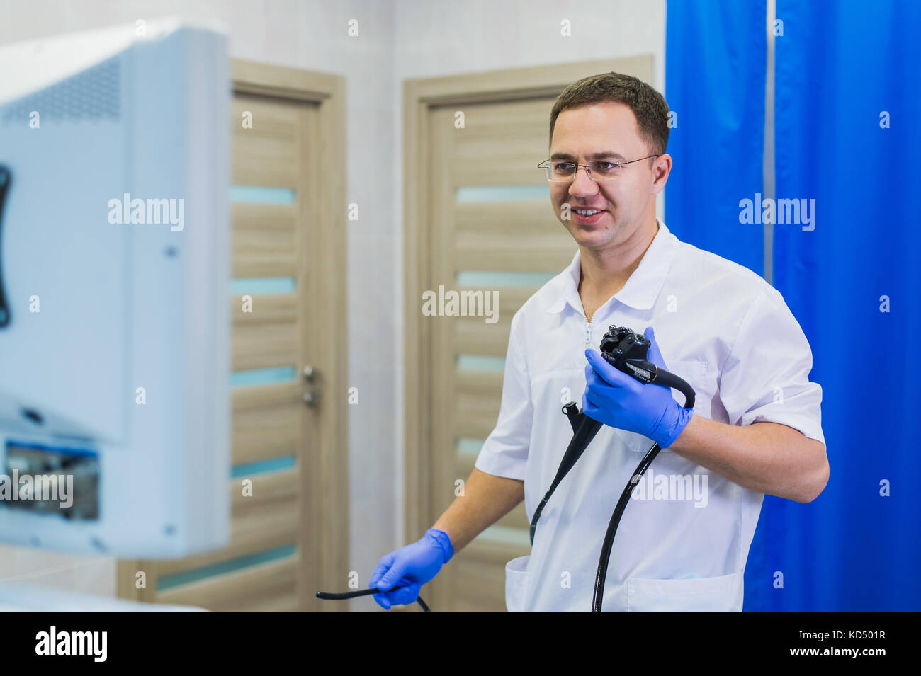 proctologist holding anoscope at hospital ward Stock Photo - Alamy