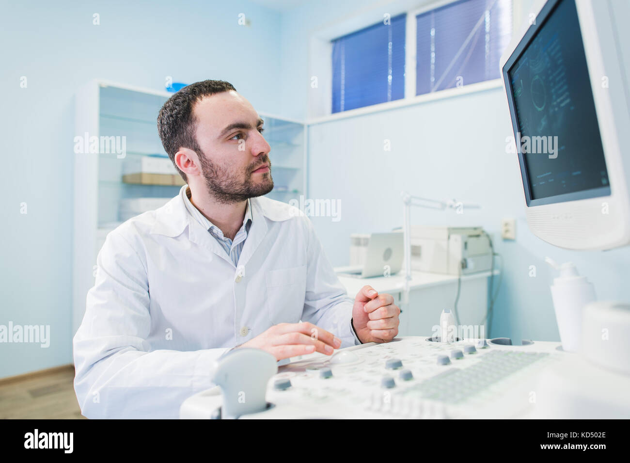 handsome doctor using an ultrasound machine Stock Photo - Alamy