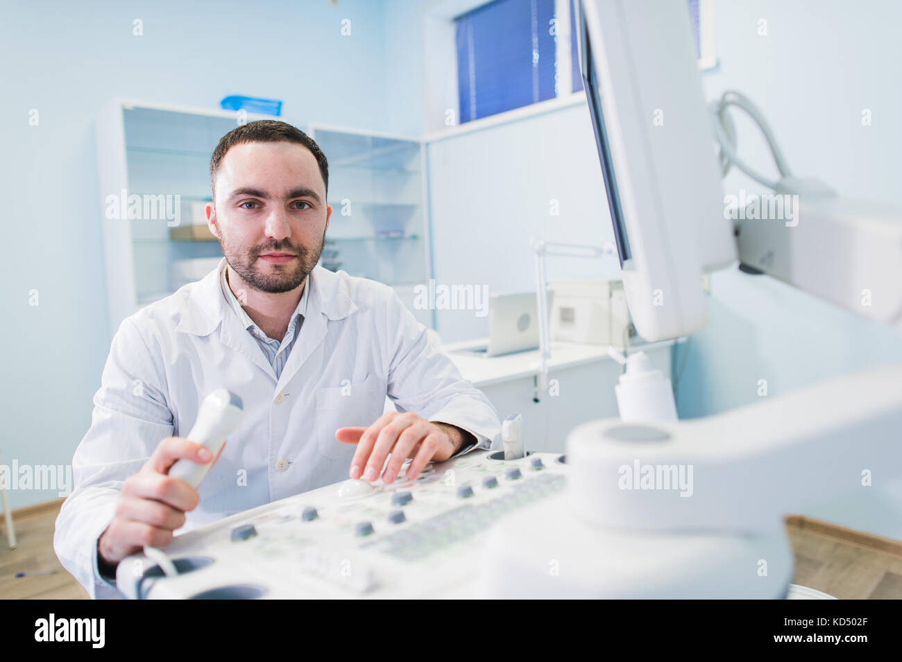 handsome doctor using an ultrasound machine Stock Photo - Alamy