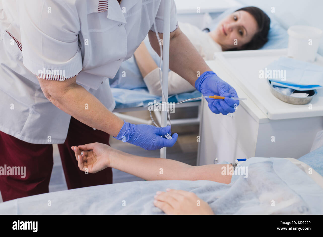 Nurse connecting an intravenous drip in hospital room Stock Photo - Alamy