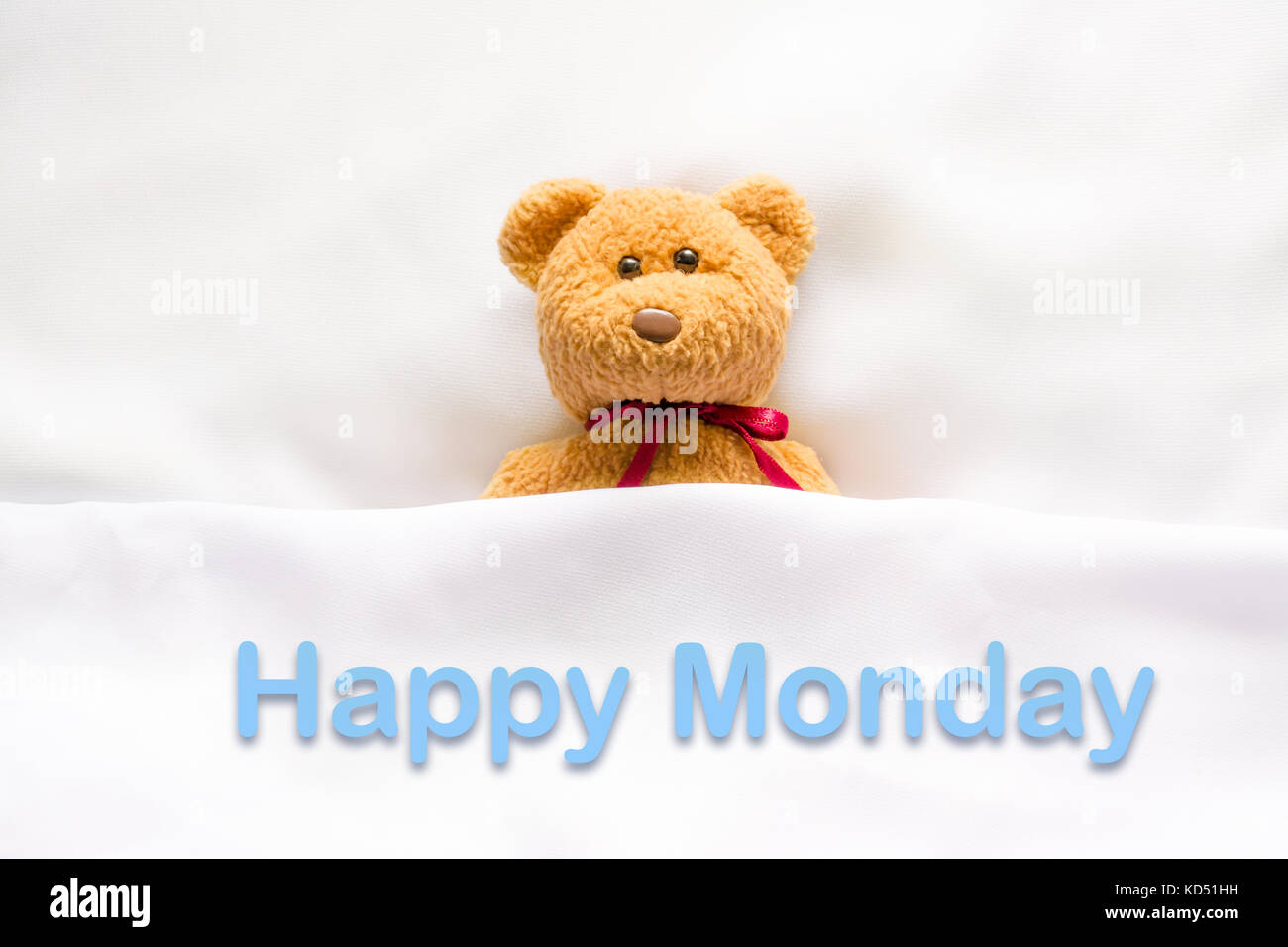 Teddy Bear lying in the white bed with message " Happy Monday Stock ...
