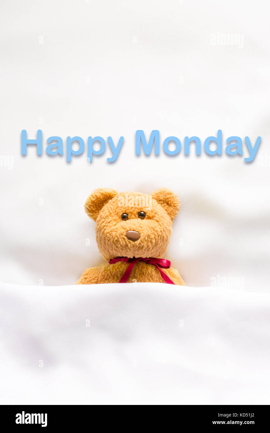 Teddy Bear lying in the white bed with message " Happy Monday Stock ...
