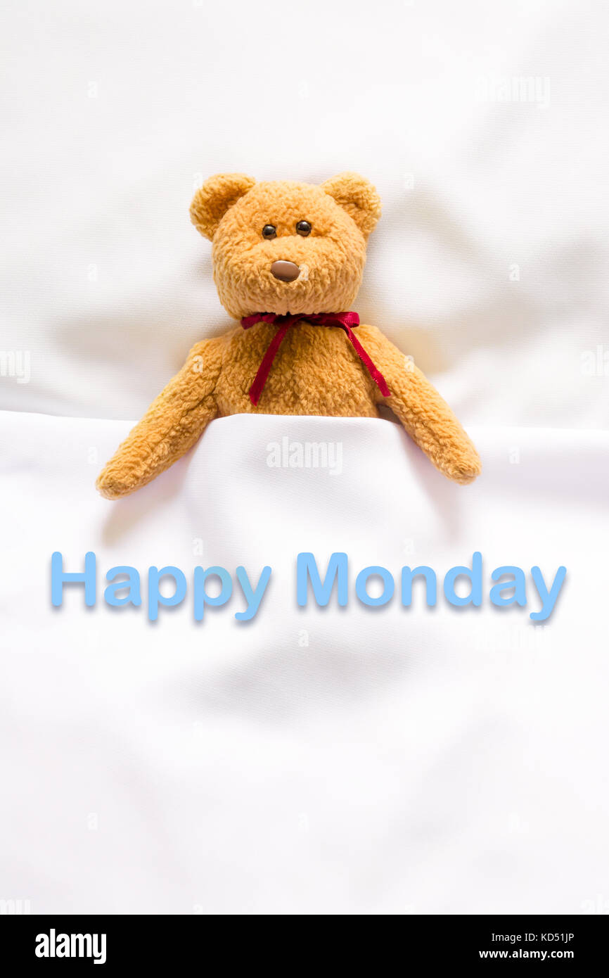 Teddy Bear lying in the white bed with message " Happy Monday Stock ...