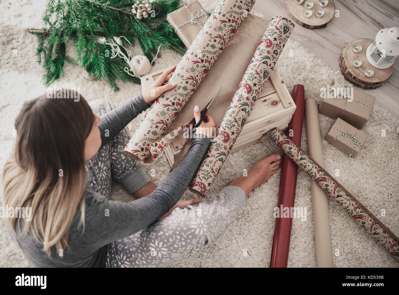 Woman flooring and cutting wrapping paper Stock Photo - Alamy
