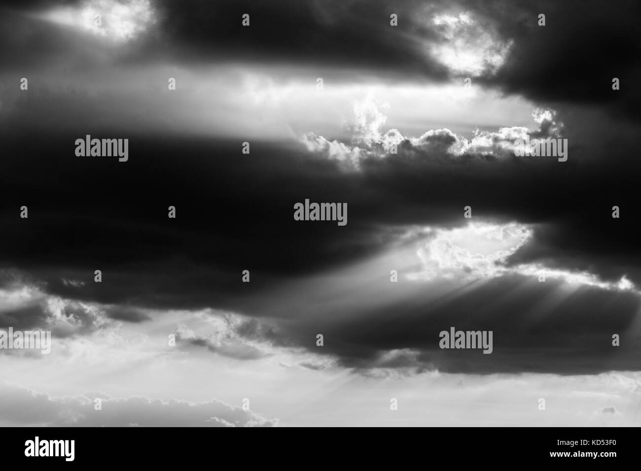 Powerful sun rays coming out through some dark clouds Stock Photo - Alamy