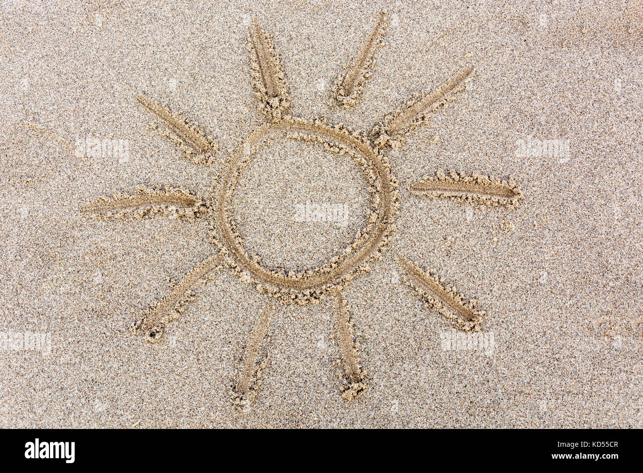 A sun drawn in the sand from above Stock Photo - Alamy