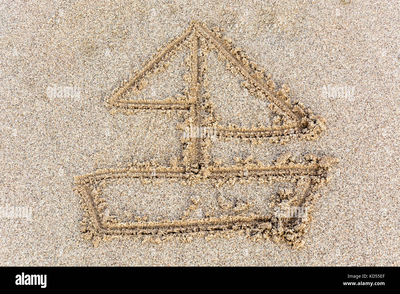 A sailing boat drawn in the sand from above Stock Photo - Alamy