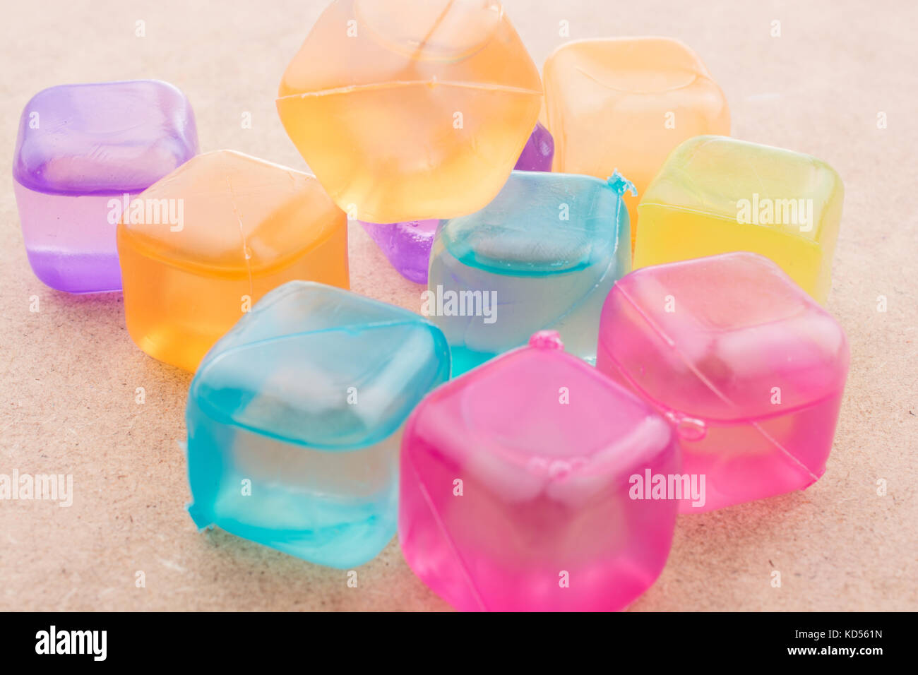 Fake colorful ice cubes on a brown background Stock Photo - Alamy