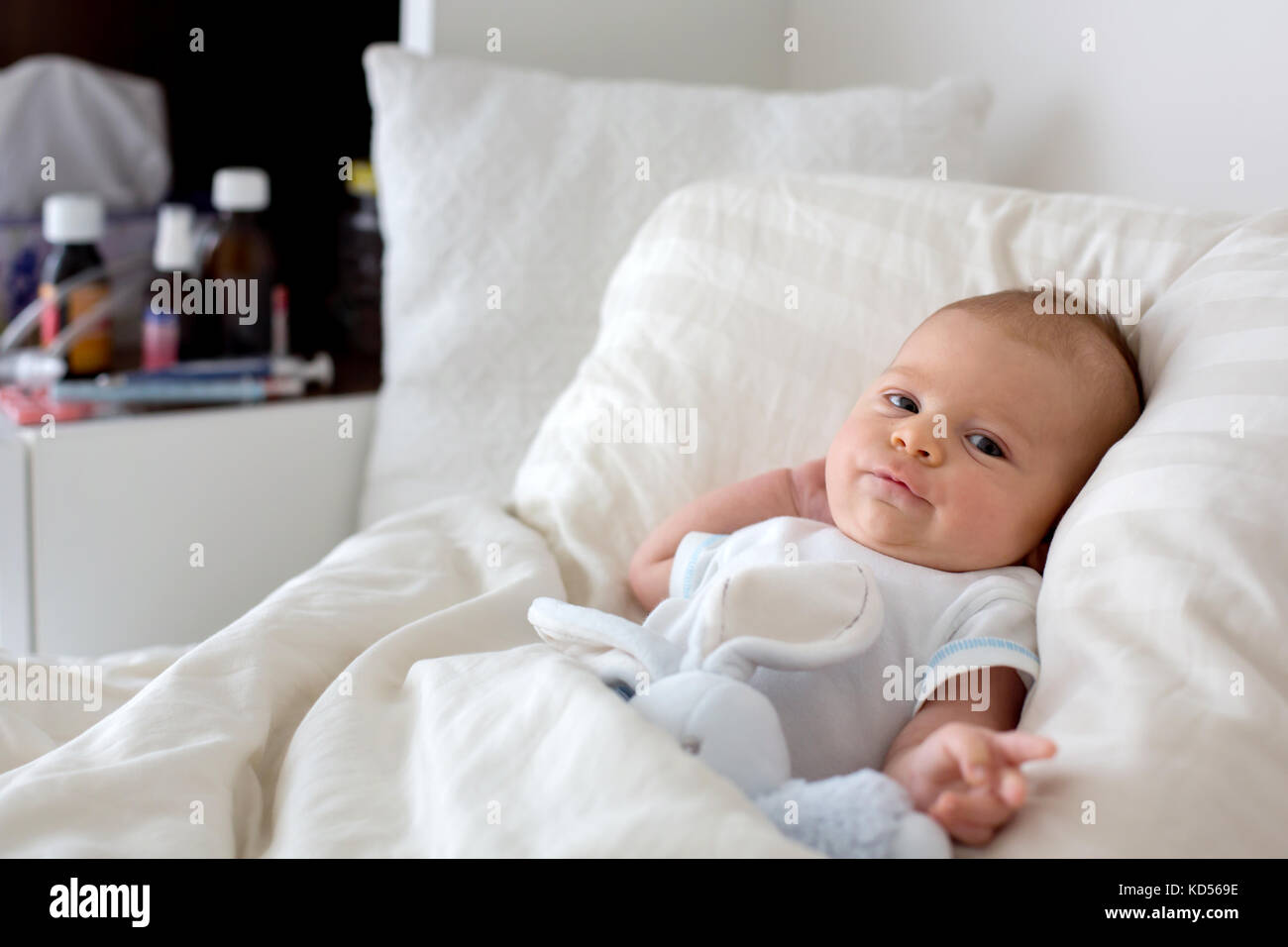 Cute baby boy, lying in bed with cold and fever Stock Photo - Alamy