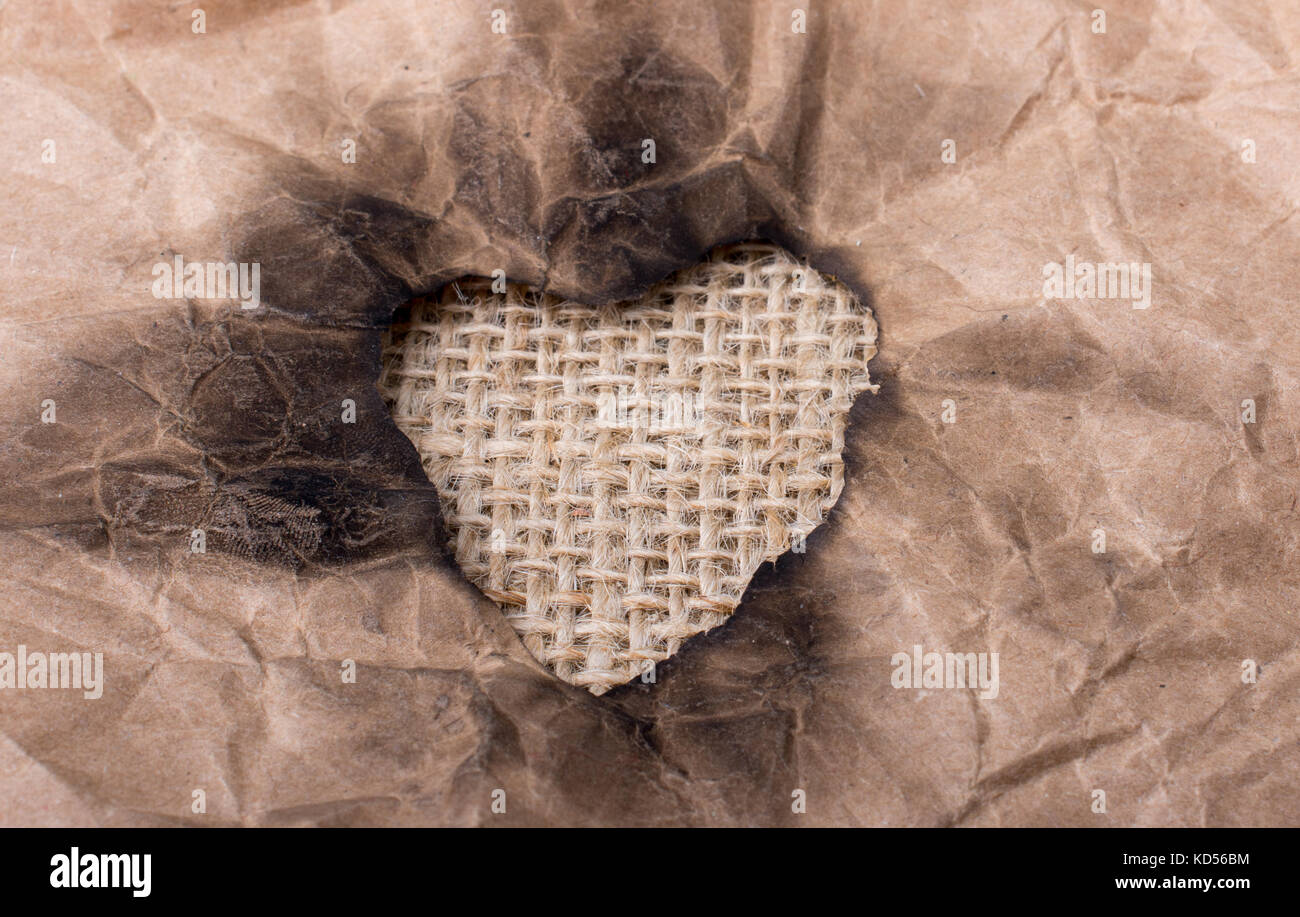 Heart shaped burnt out of a brown paper Stock Photo - Alamy