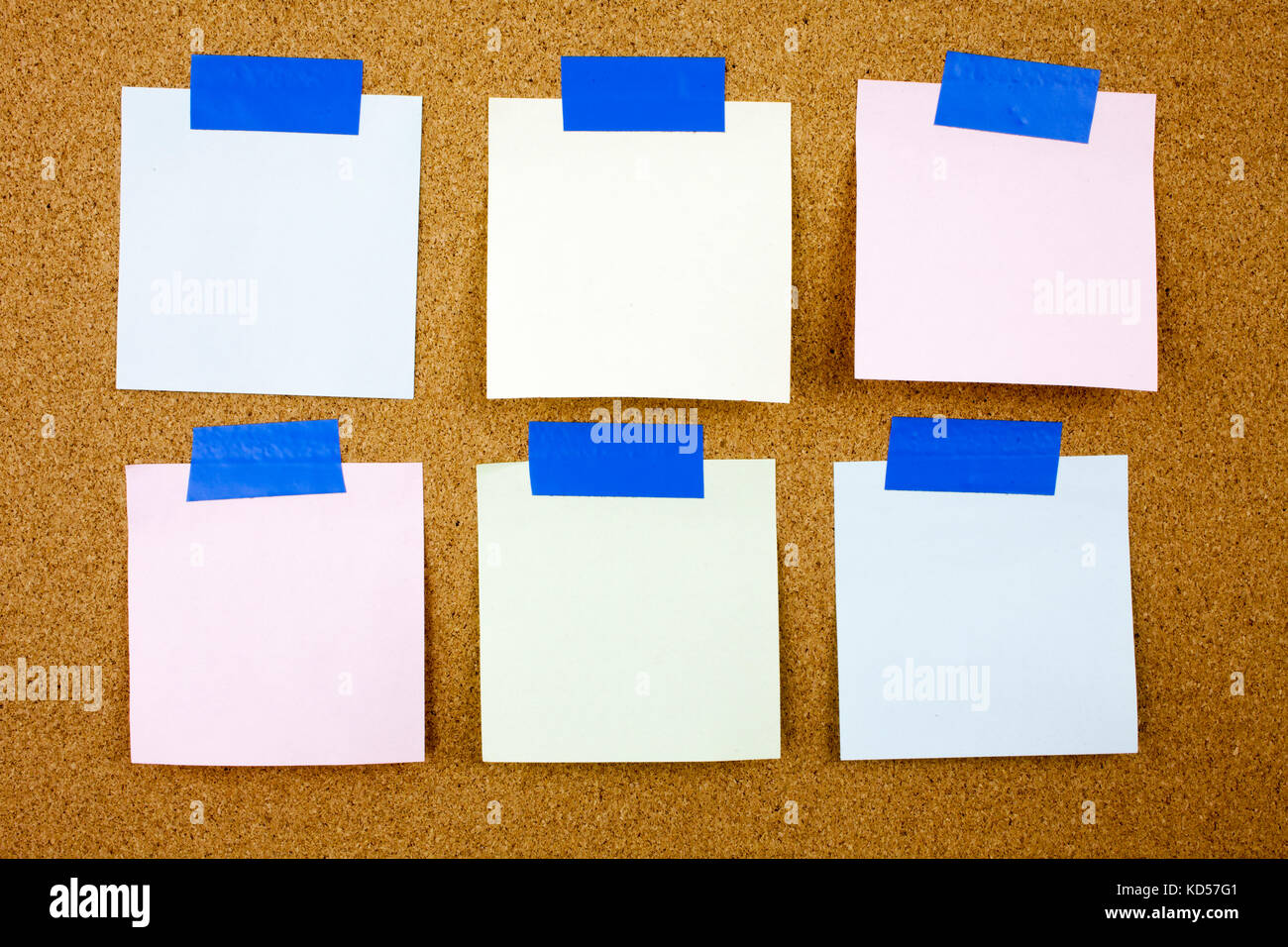 A yellow sticky note writing, caption, inscription Cork board with six ...