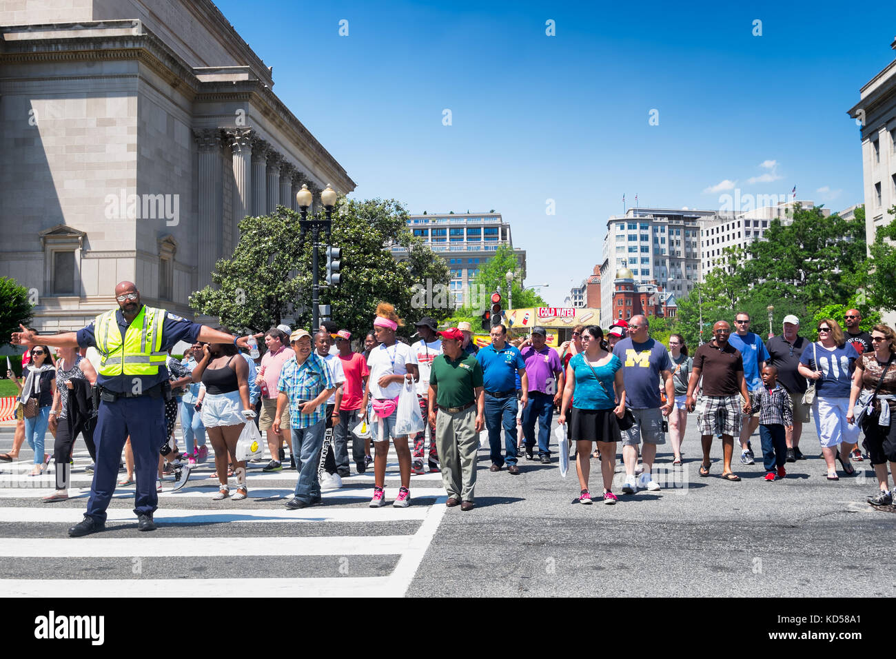 WASHINGTON DC - MAY 25, 2015: A traffic policeman stops a big crowd of ...