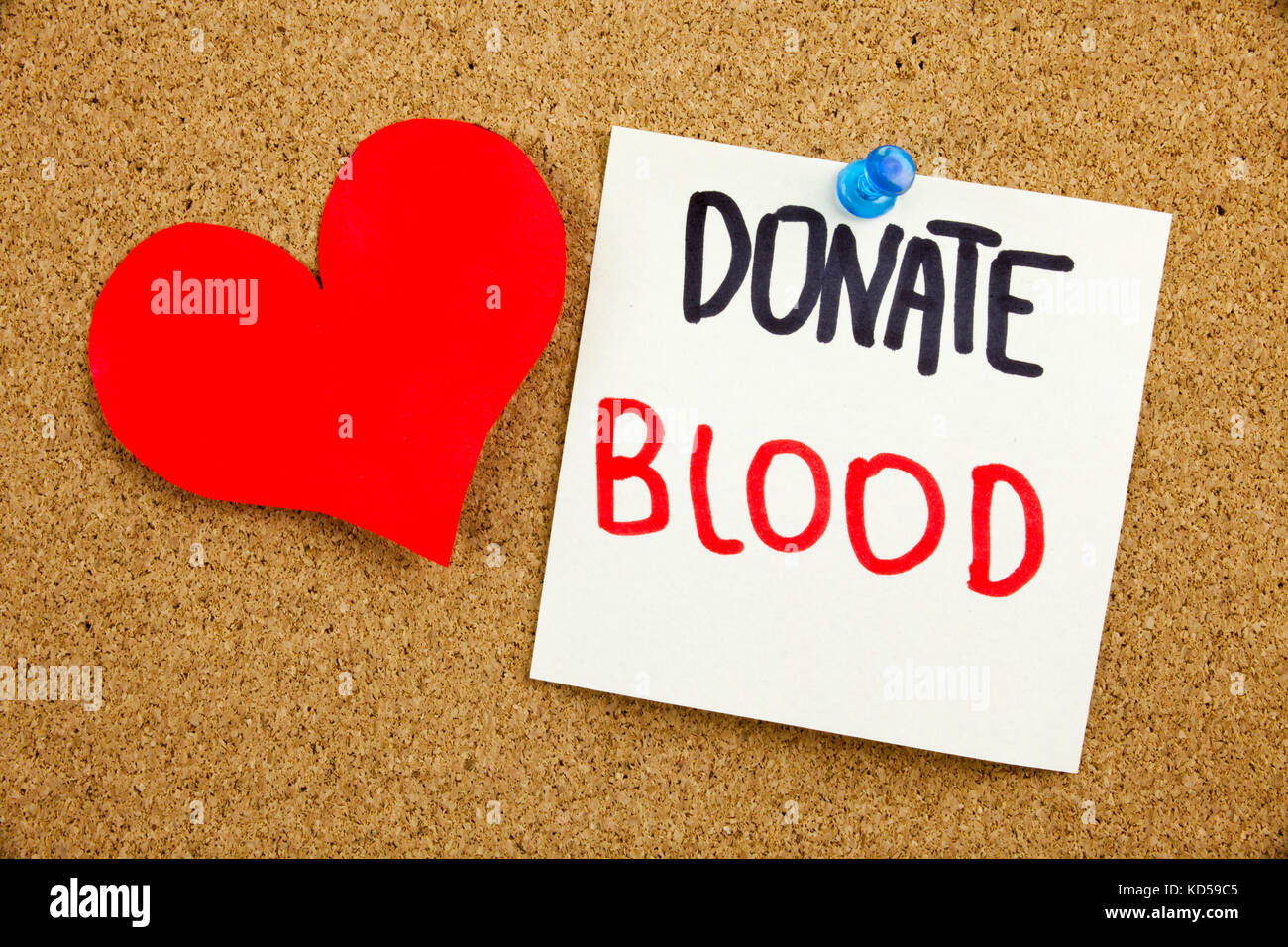 A yellow sticky note writing, caption, inscription Phrase DONATE BLOOD ...