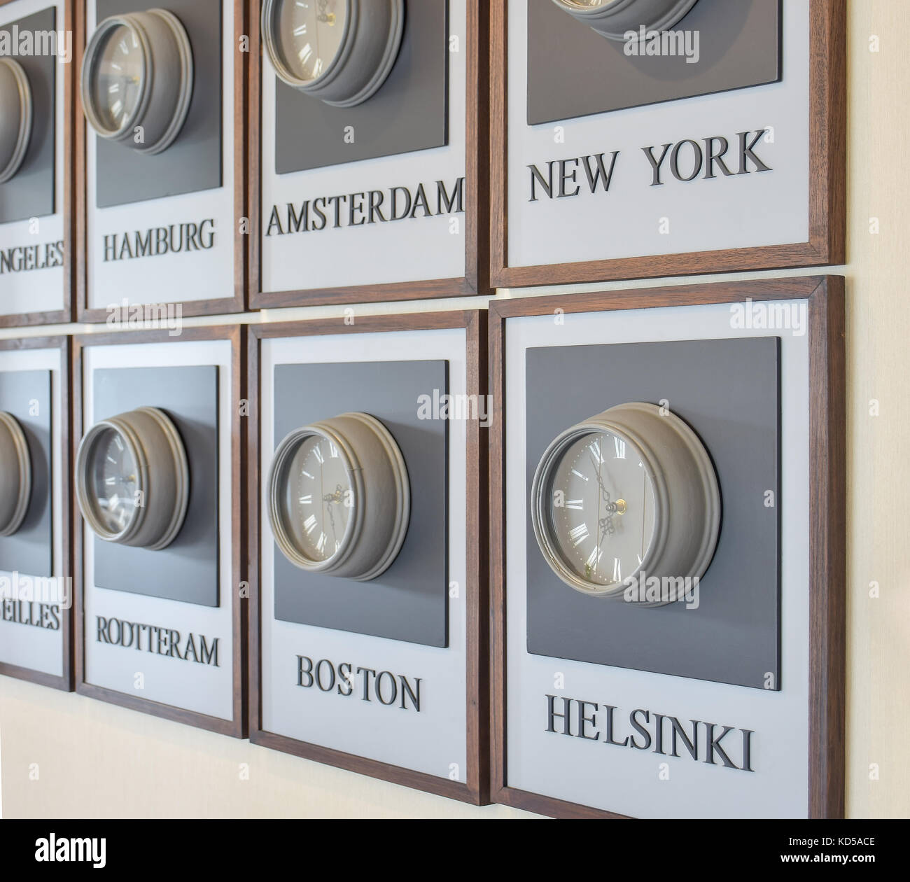 wooden clocks showing the time in different cities of the world on the ...