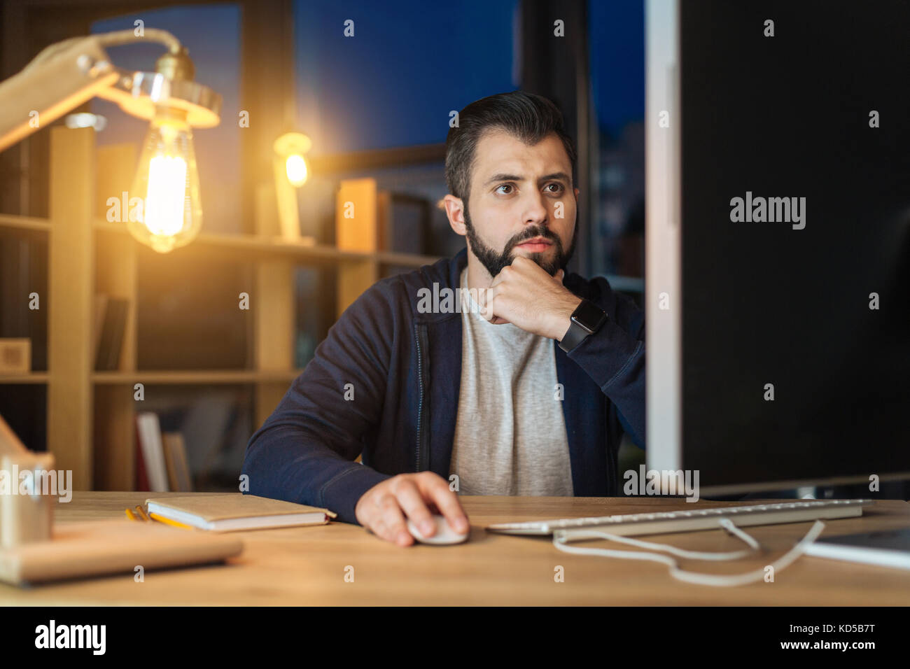 Concentrated programmer being in office at night Stock Photo - Alamy