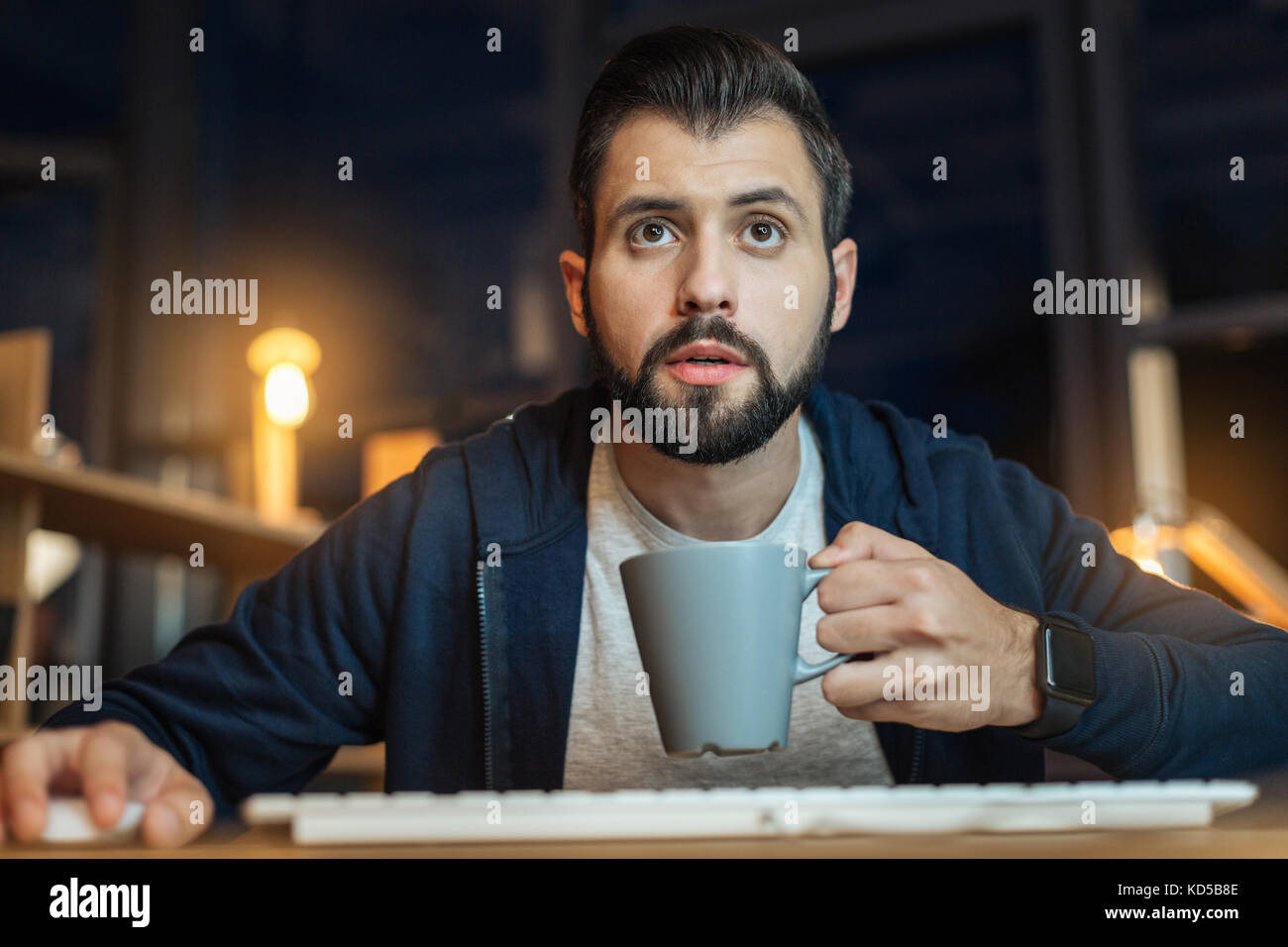Busy bearded man finishing his project work Stock Photo - Alamy