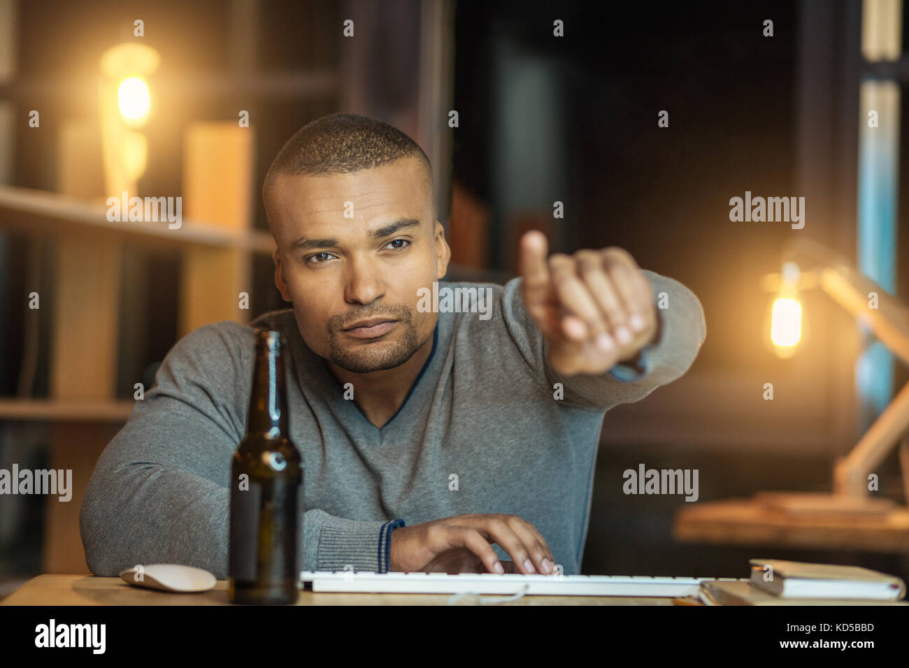 Concentrated man pointing at screen Stock Photo - Alamy