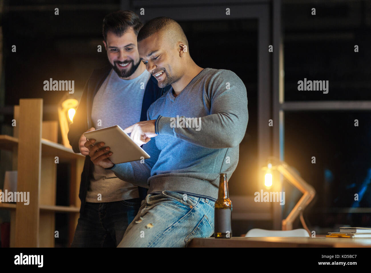 Delighted male person testing his gadget Stock Photo - Alamy