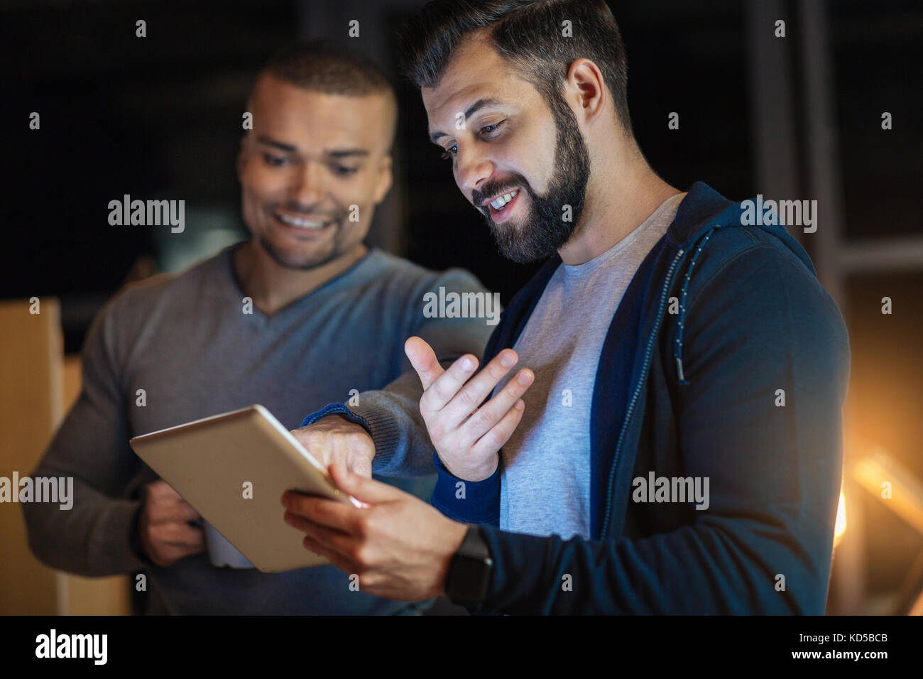 Attentive man looking at his device Stock Photo - Alamy