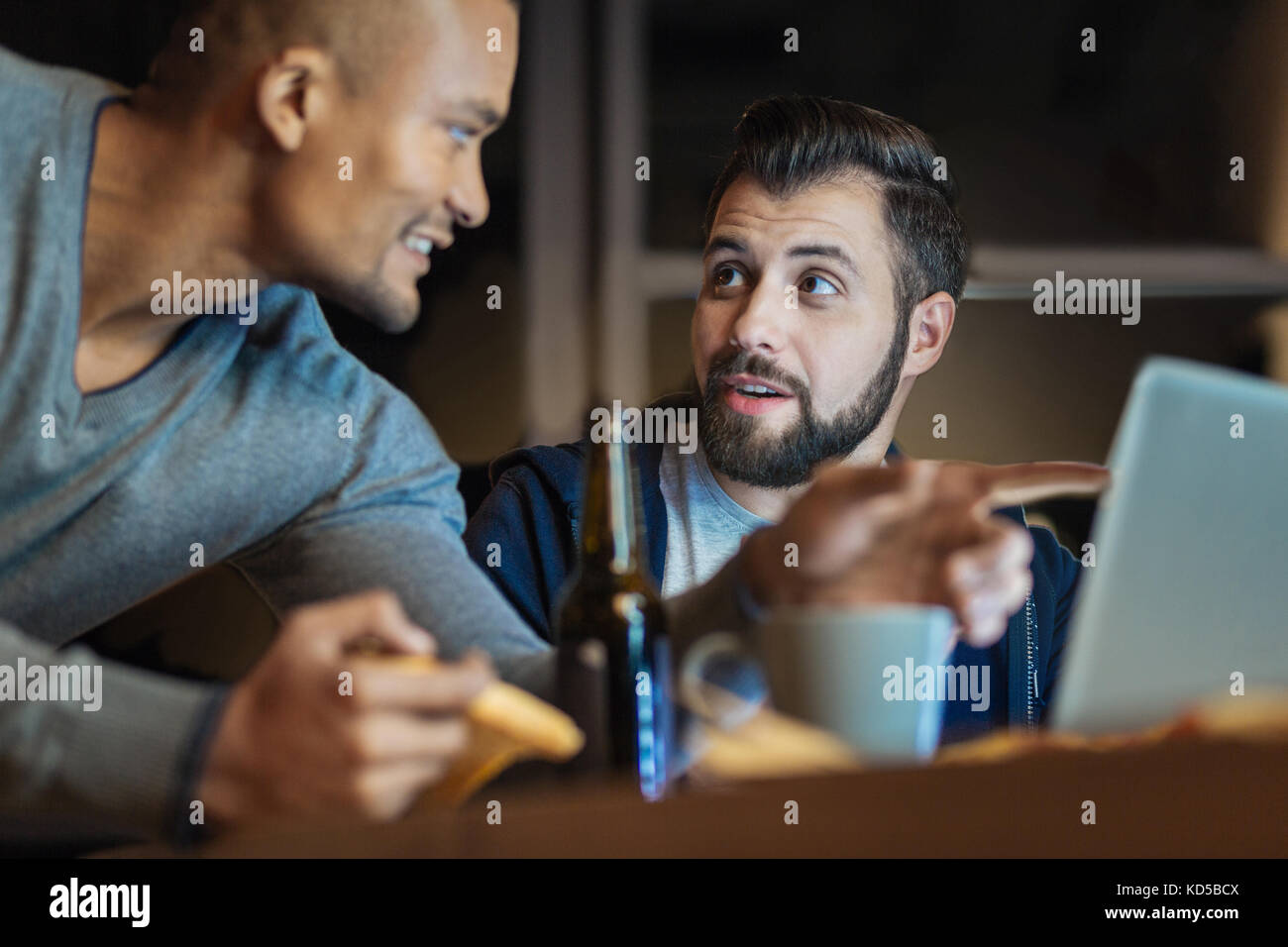 Delighted man pointing at computer Stock Photo - Alamy