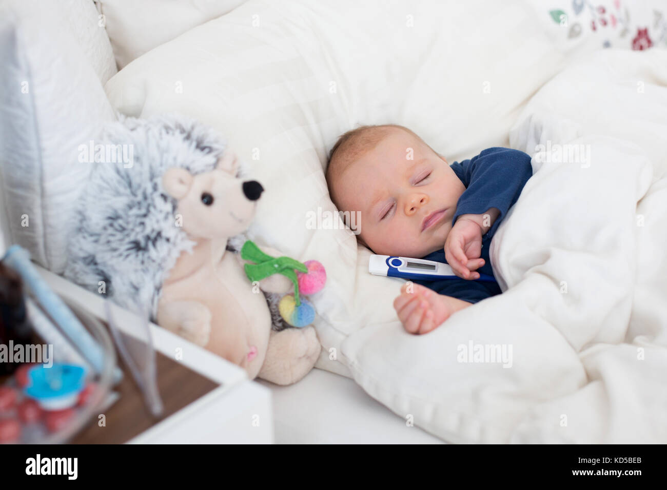 Cute newborn baby boy, lying in bed with cold and fever Stock Photo - Alamy