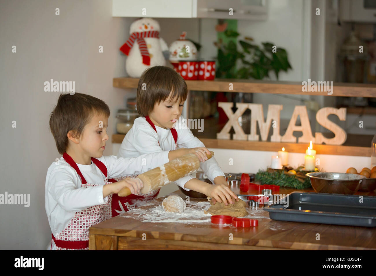 Two sweet children, boy brothers, preparing gingerbread cookies for ...