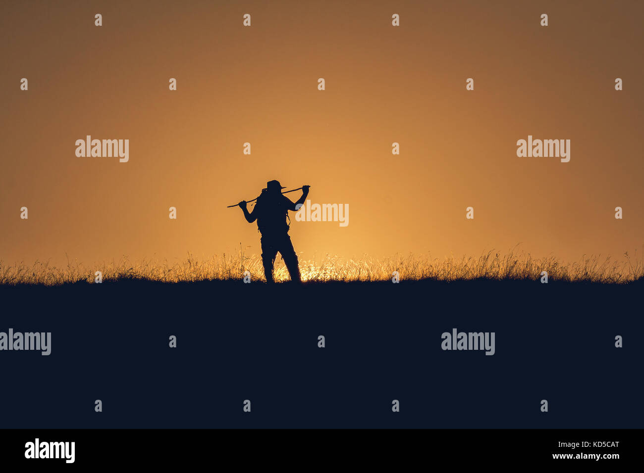 Silhouette Of backpacker having fun at sunset time Stock Photo - Alamy