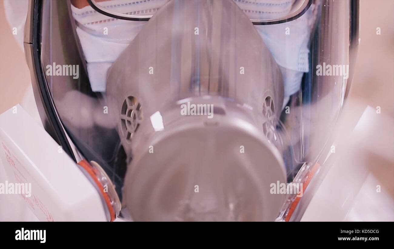 Scientist in protective clothing with respirator. Infection control ...