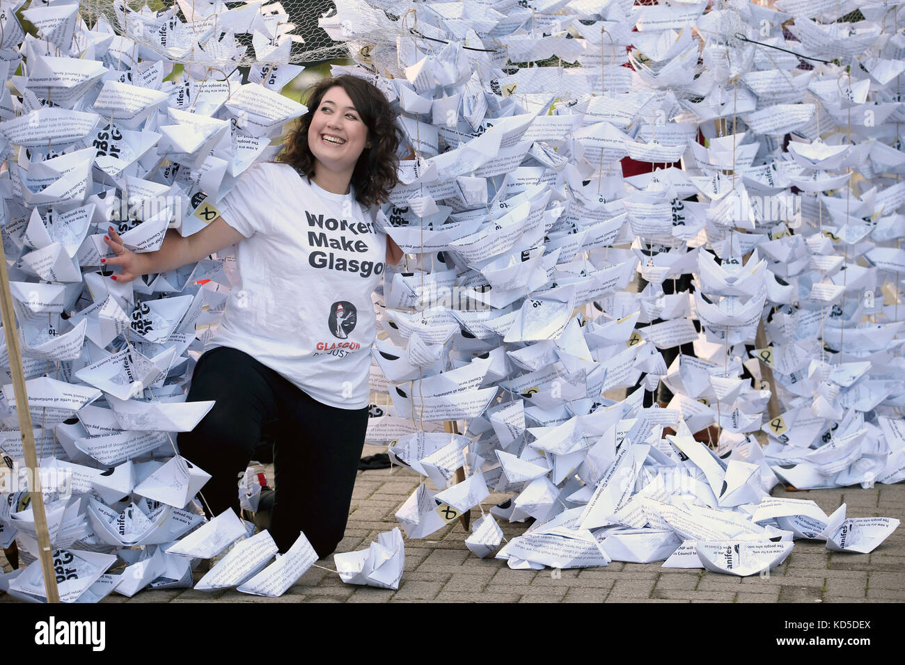 GMB Scotland branch secretary Rhea Wolfson poses with 2,000 paper boats ...