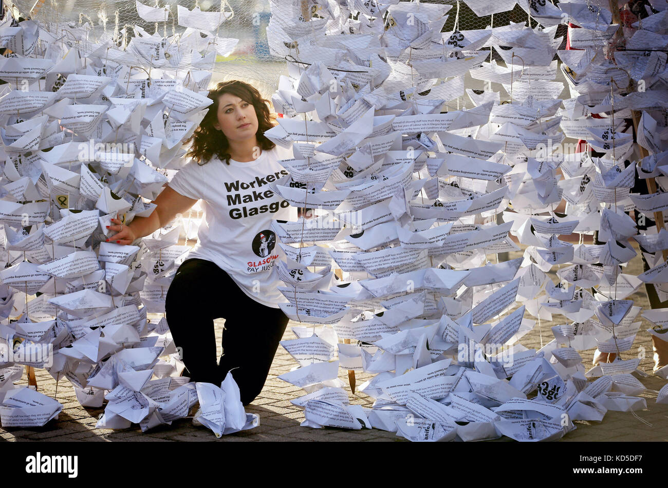 GMB Scotland branch secretary Rhea Wolfson poses with 2,000 paper boats ...