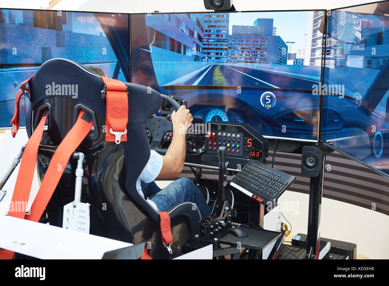 Man plays on a computer racing simulator Stock Photo - Alamy