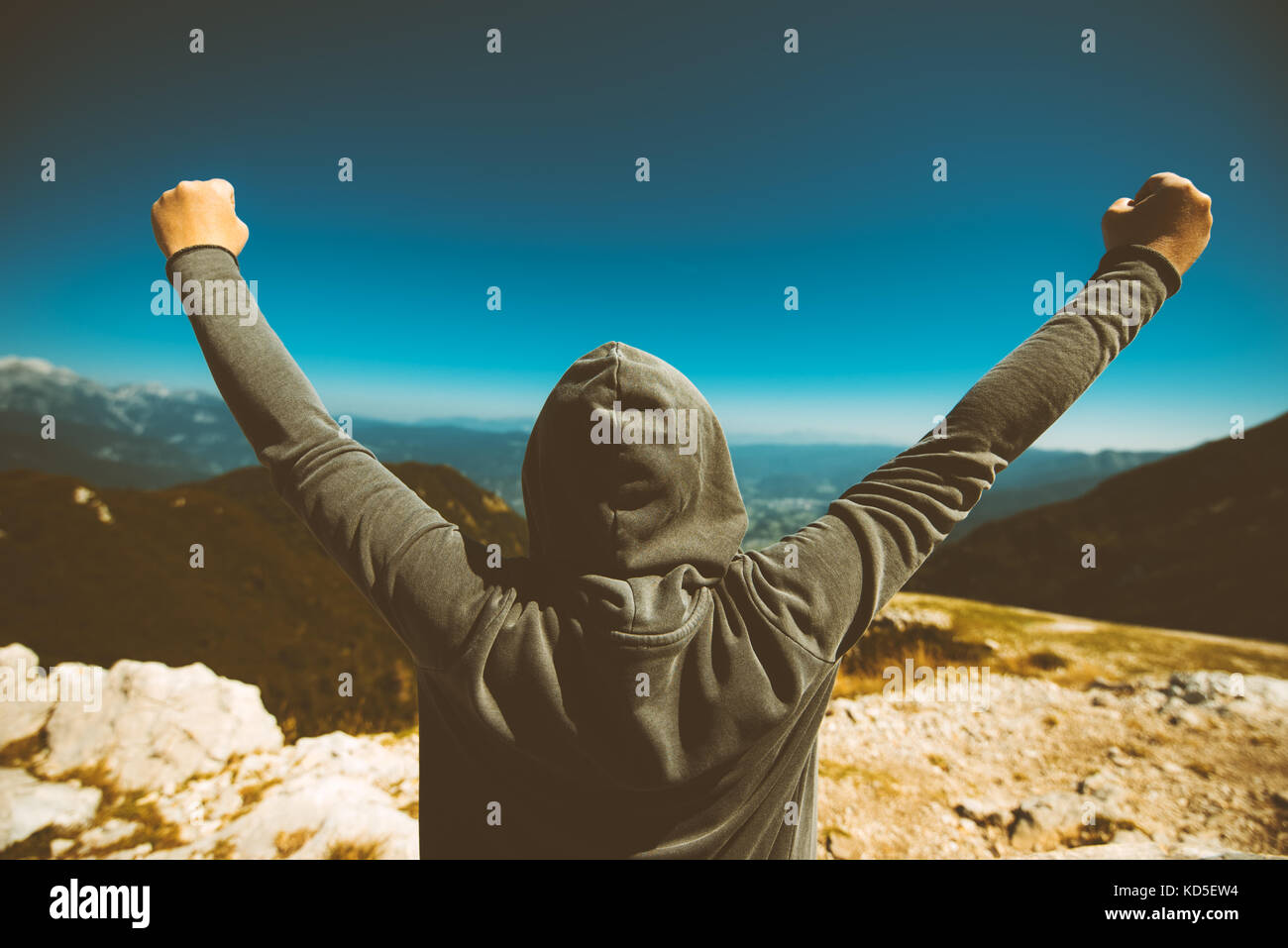 Achievement and triumph. Victorious female person standing on mountain ...