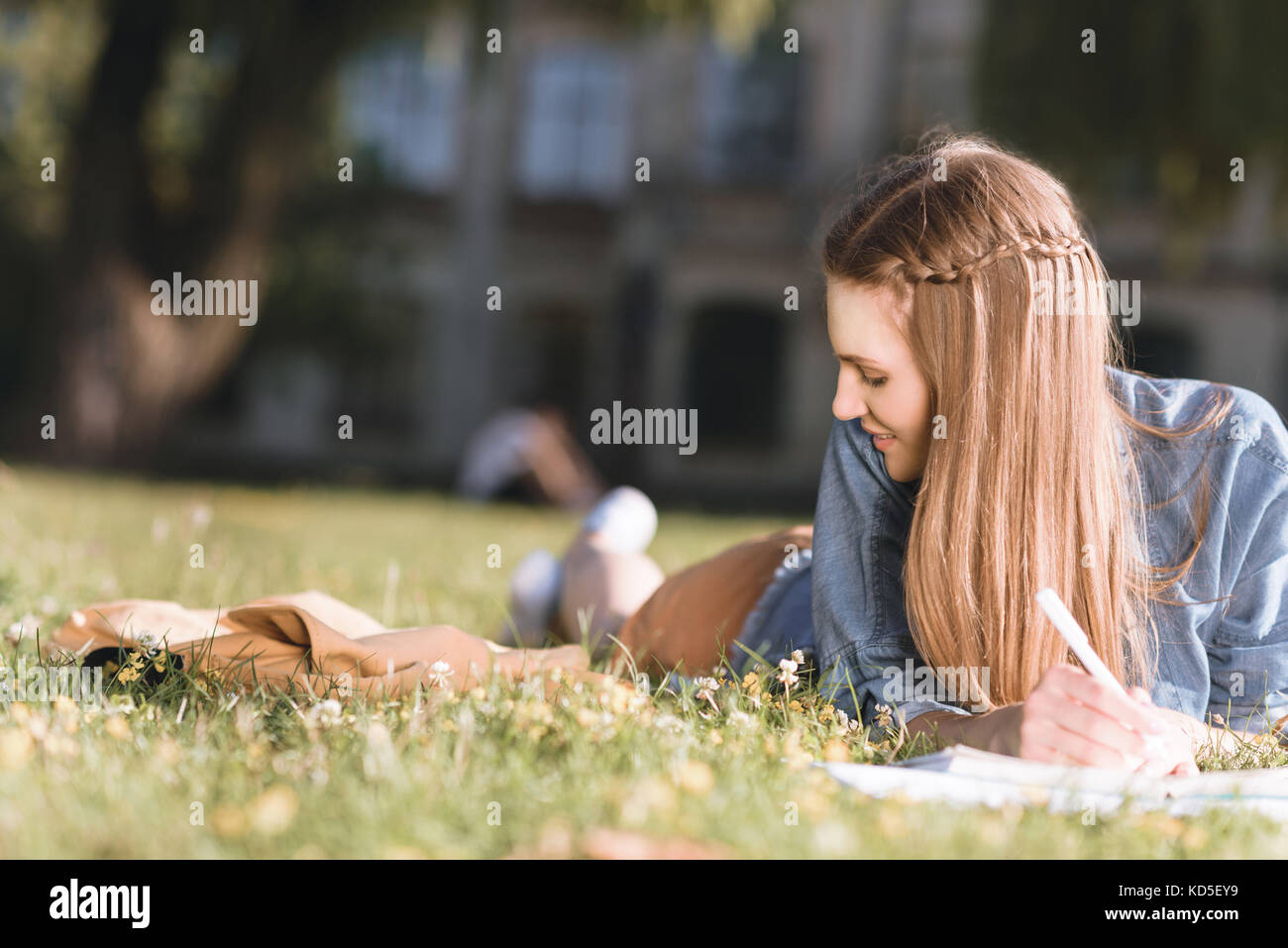 young woman studying in park Stock Photo - Alamy